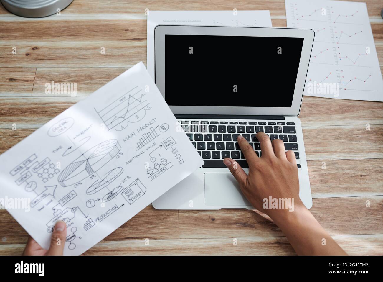 Hands of entrepreneur checking general idea chart and entering ...