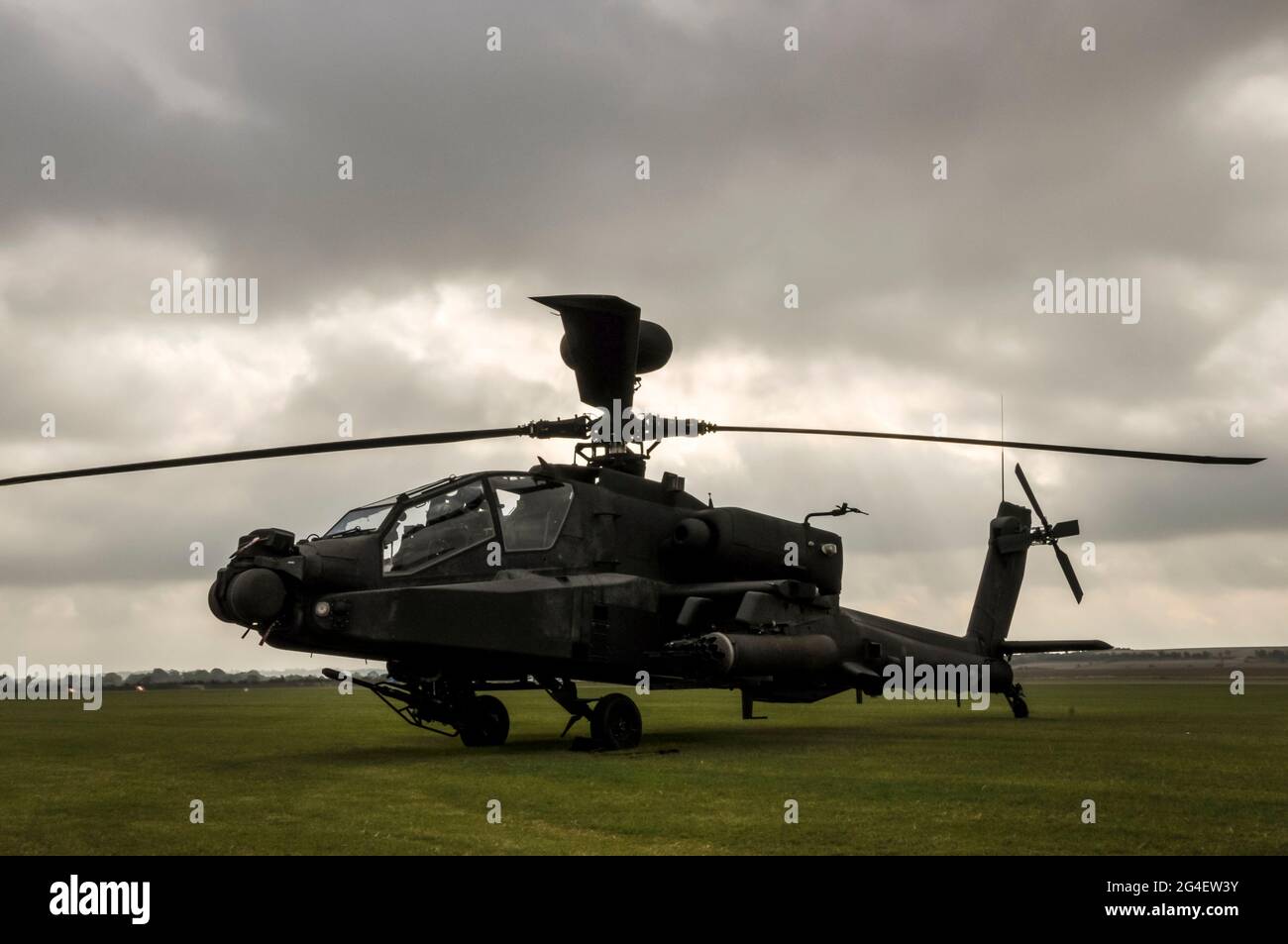 Worn looking British Army Apache gunship sitting under a heavy ...