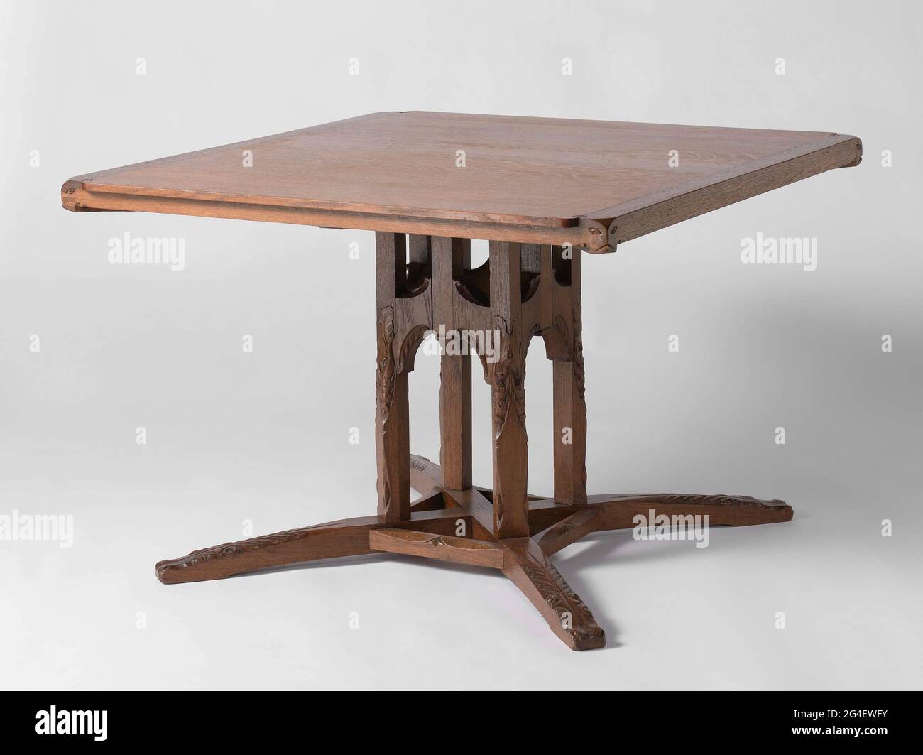 . Square table of oak resting on an open trunk and a diagonally placed ...