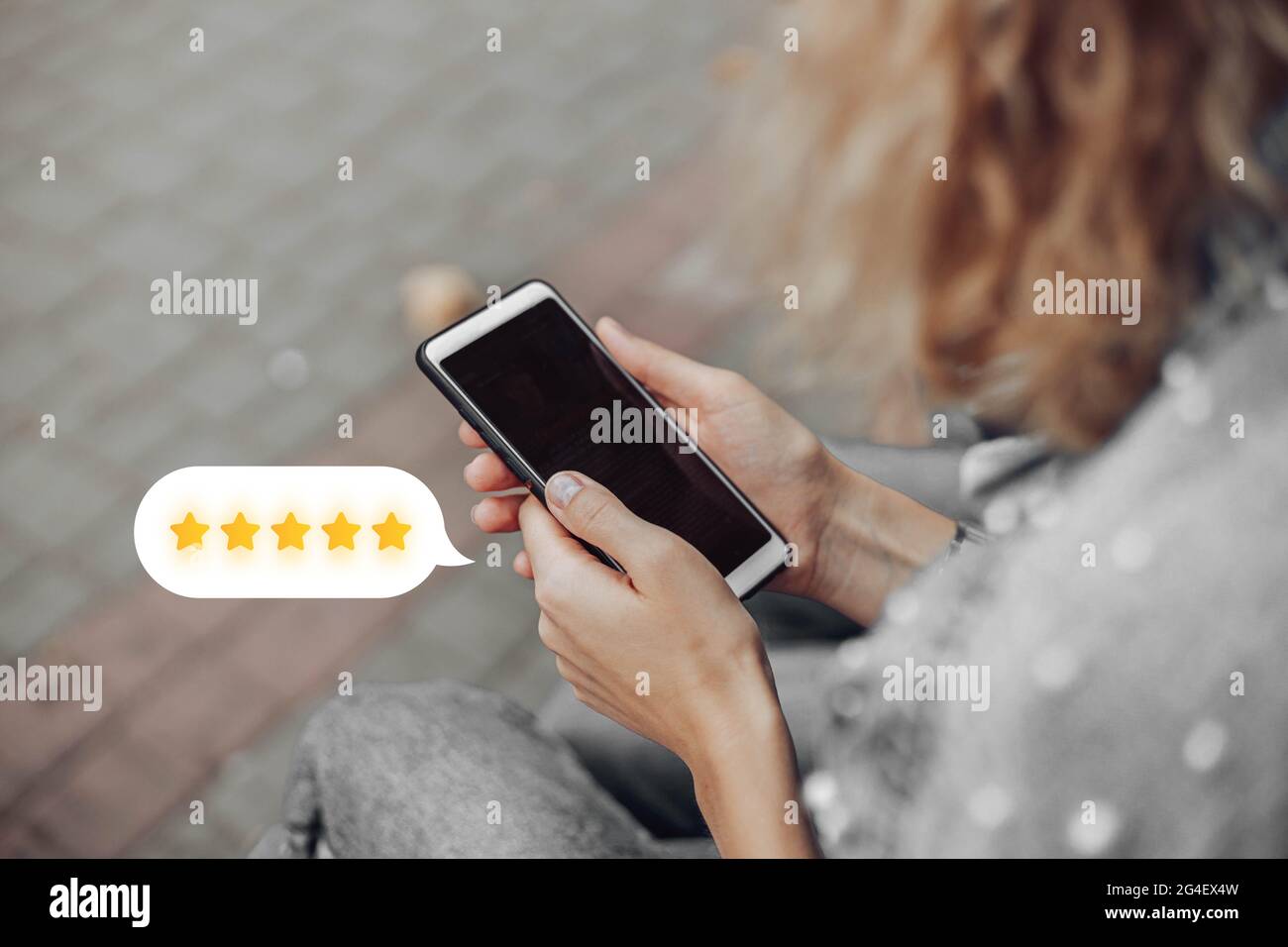 Woman hand using smart phone with icon five star symbol to increase ...