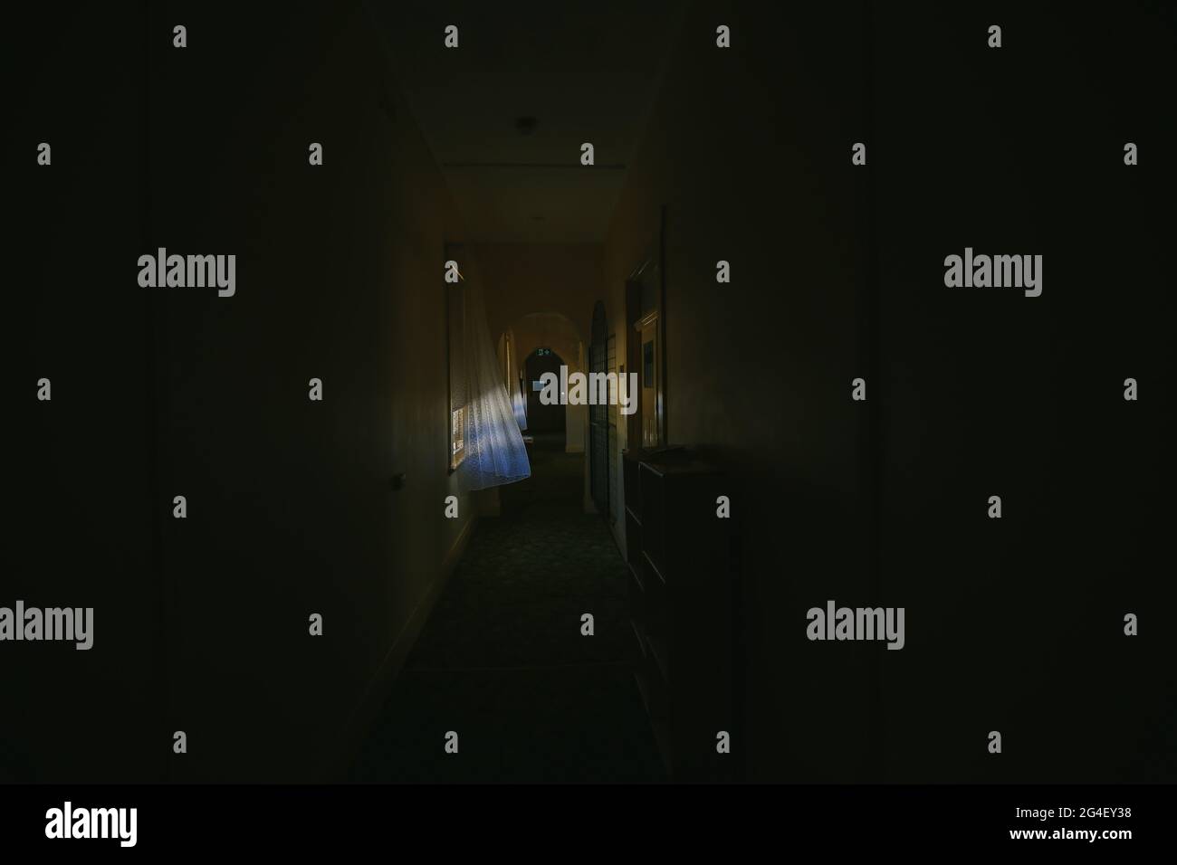 The light from the window shining the long dark corridor in the house ...