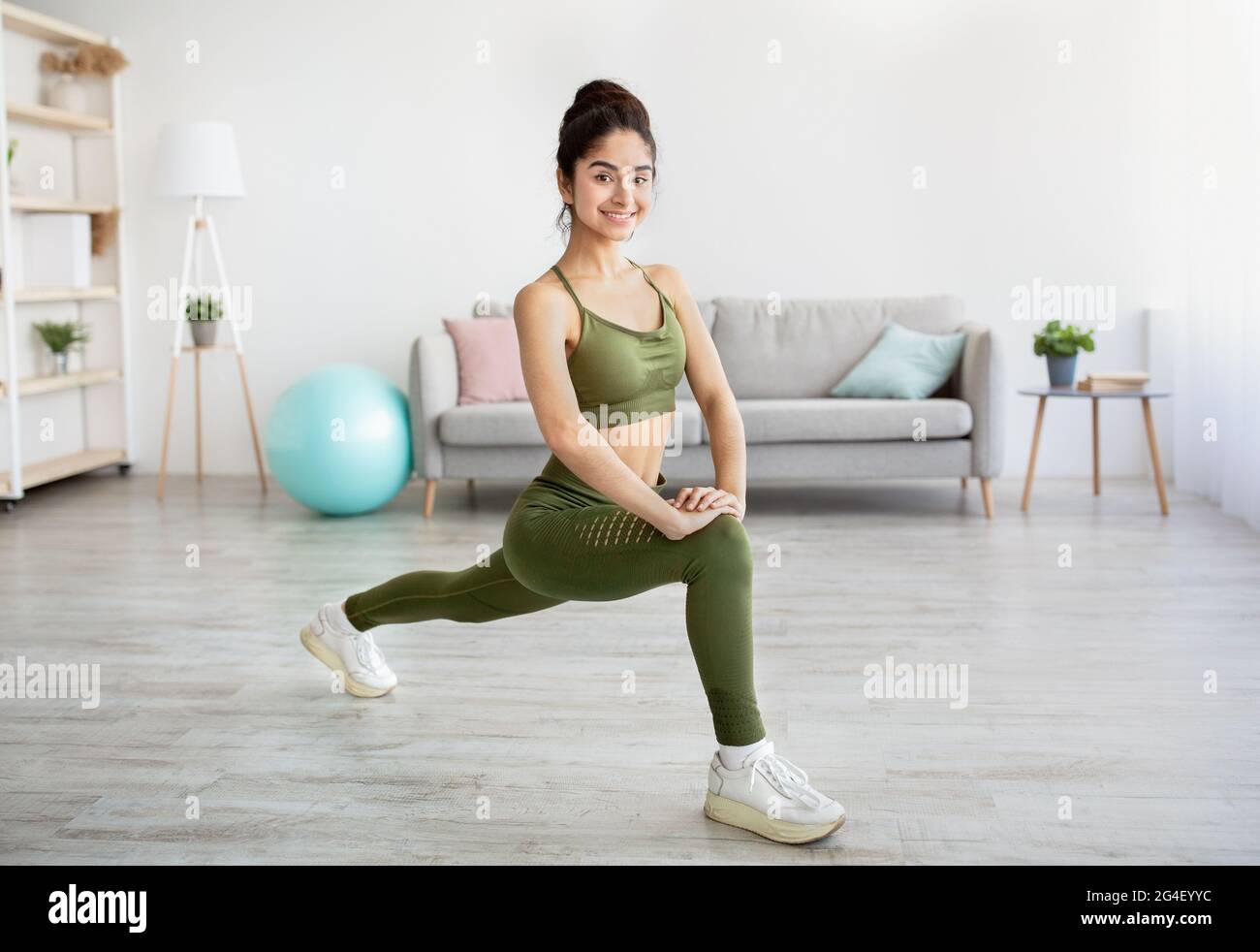 Domestic training on quarantine. Attractive young Indian lady making ...