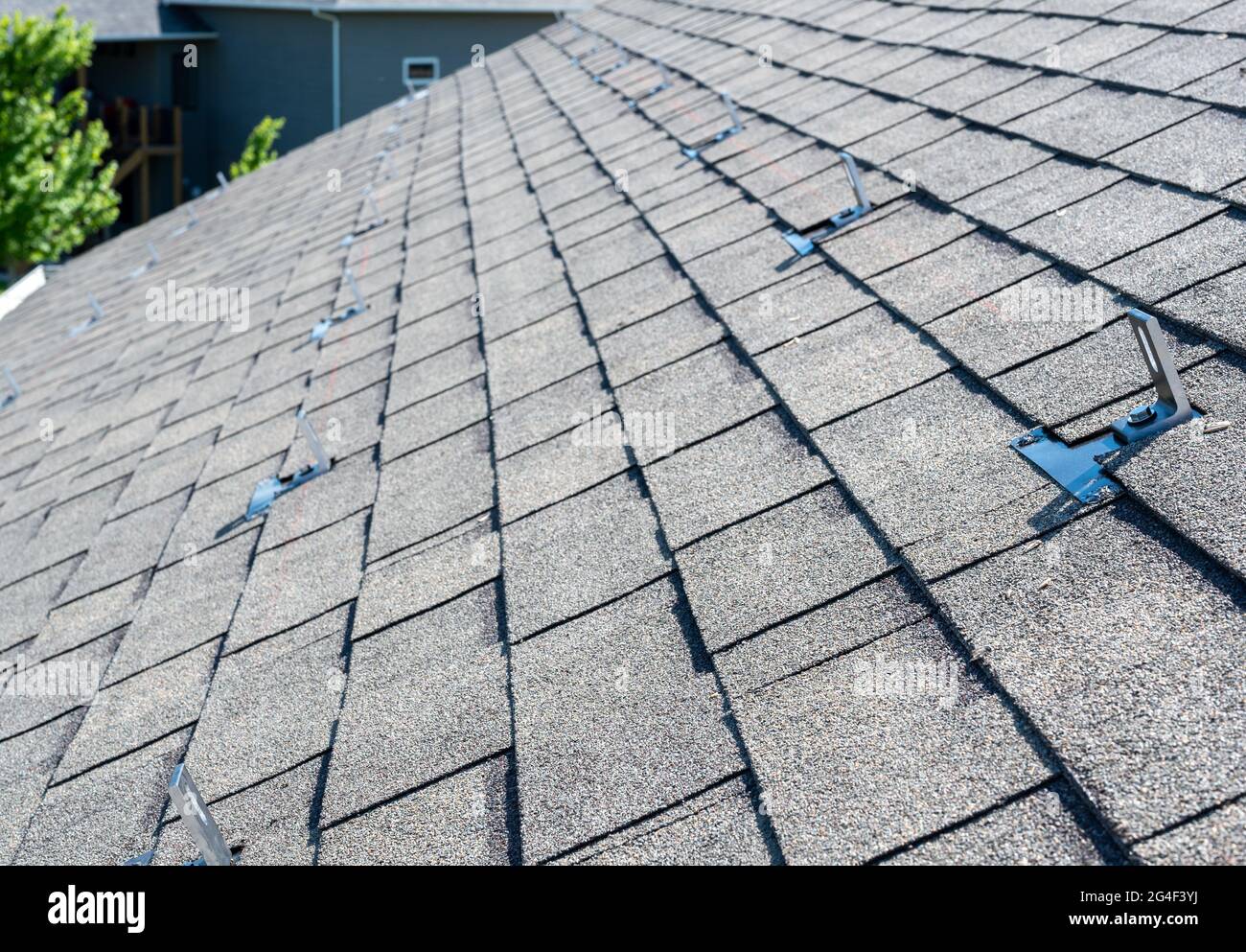 Residential asphalt shingle roof with metal anchors installed for the ...
