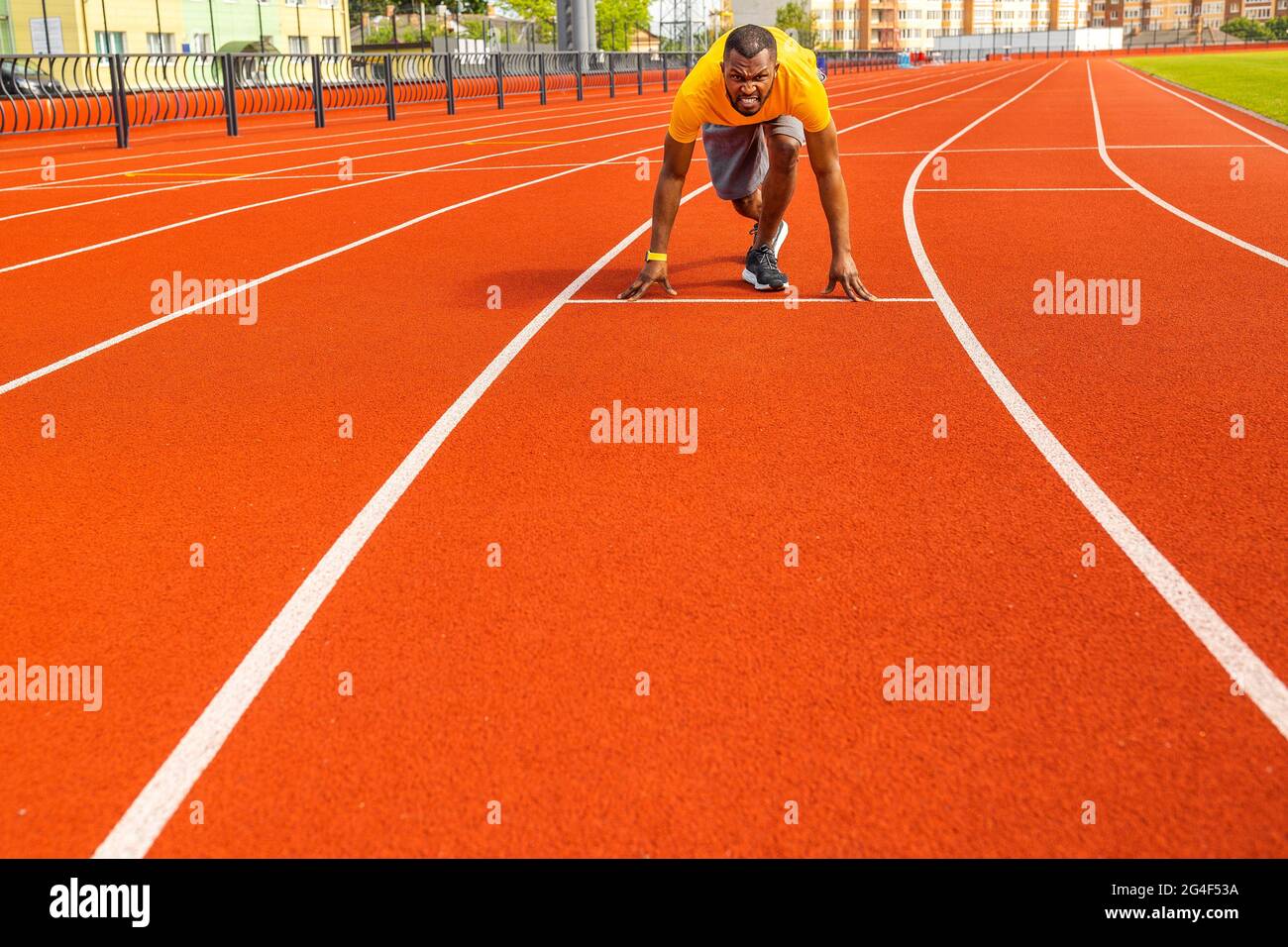 Fit focused afro-american male sportsman training hard and standing on ...