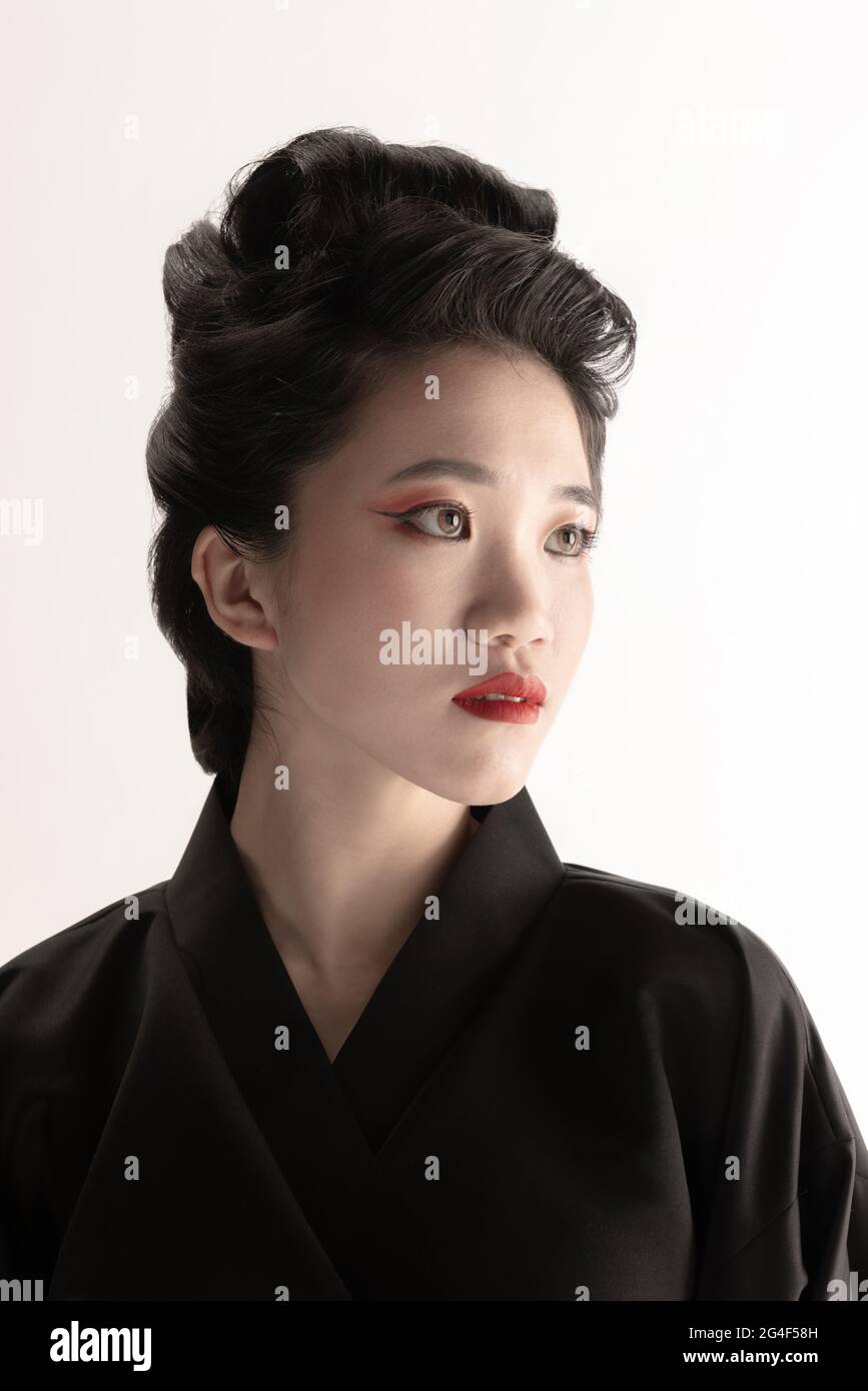 Portrait of young beautiful Japanese, woman in national attire kimono ...