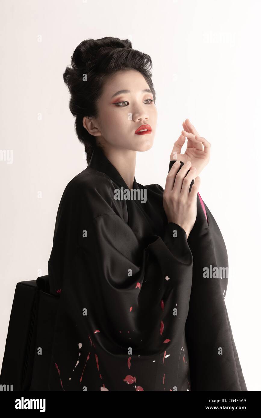 Portrait of young beautiful Japanese, woman in national attire kimono ...