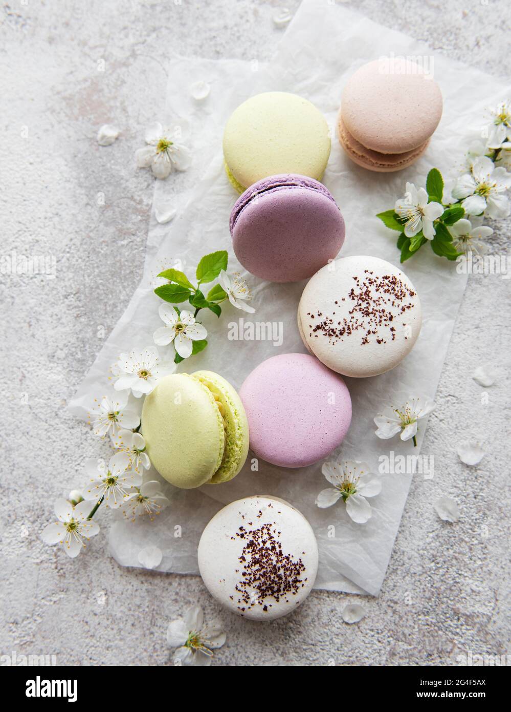 French sweet macaroons colorful variety on a concrete background with ...