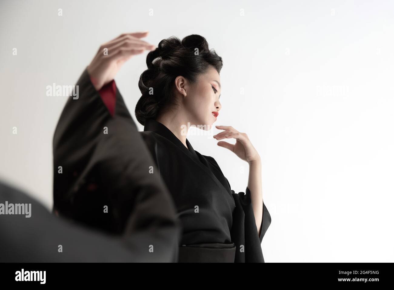 Portrait of young beautiful Japanese, woman in national attire kimono ...