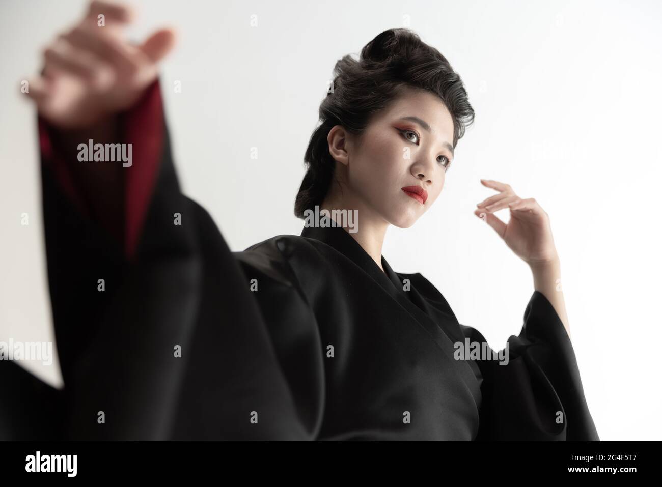 Portrait of young beautiful Japanese, woman in national attire kimono ...