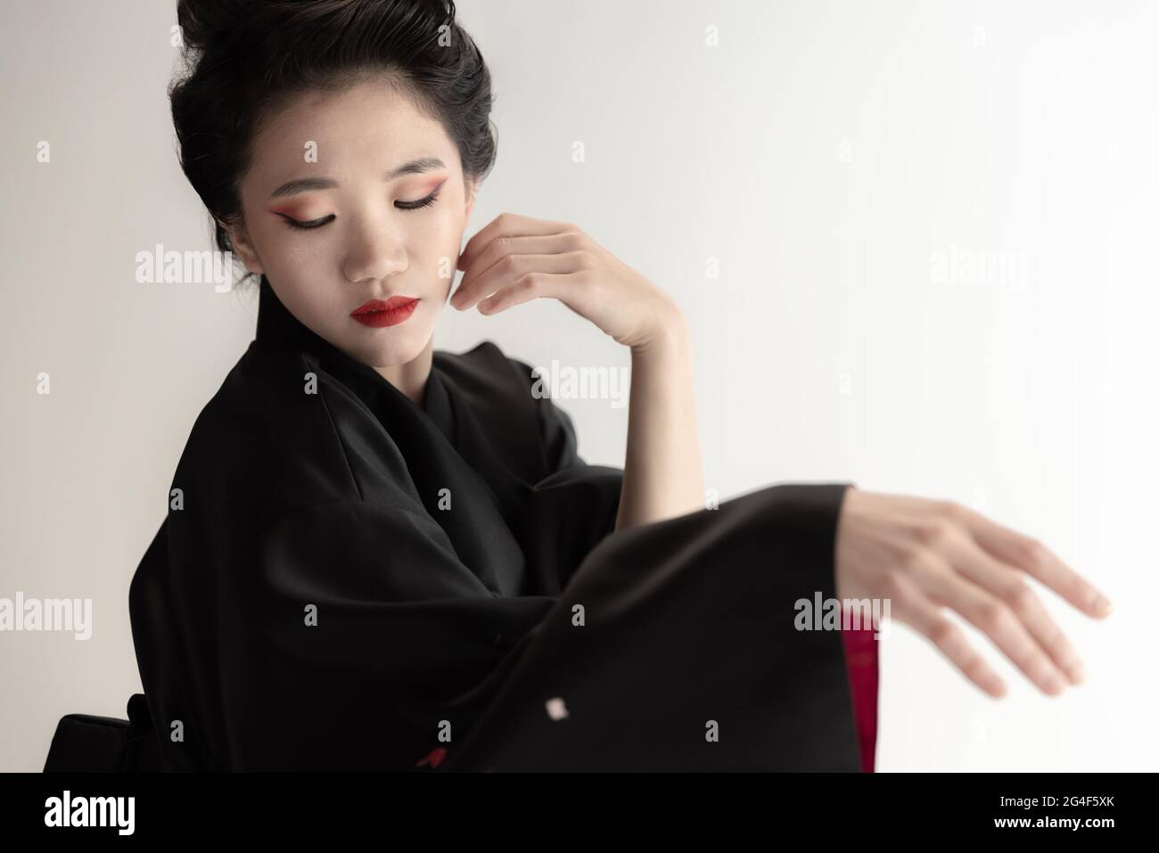 Portrait of young beautiful Japanese, woman in national attire kimono ...