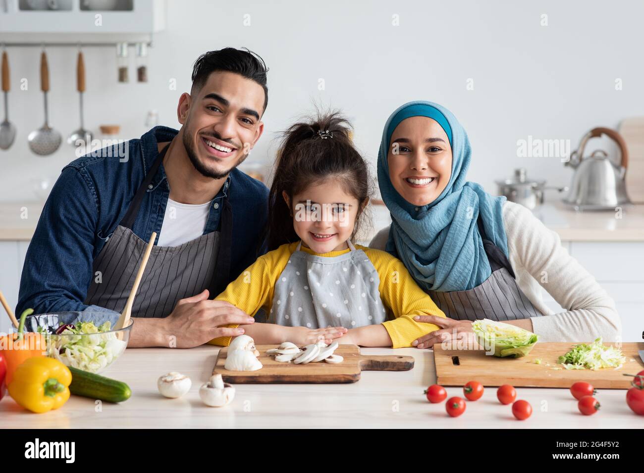 Portrait Of Happy Young Middle Eastern Family Cooking Together In ...