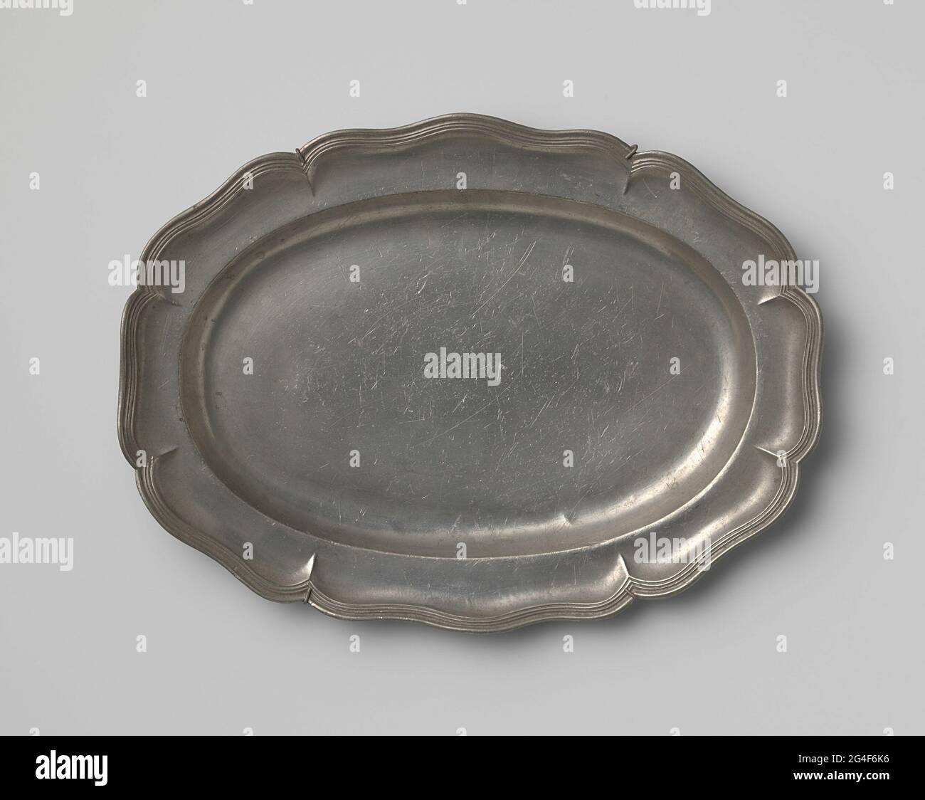Oval dish with scalloped edge. Oval dish of tin. The edge is scalloped ...