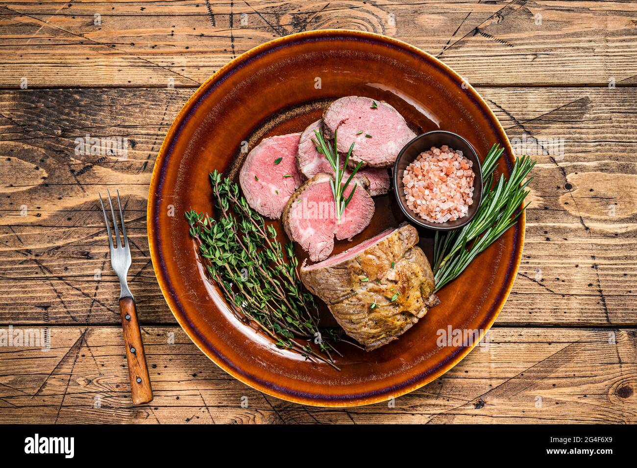 Grilled Roast beef fillet meat on a rustic plate with salt. background ...