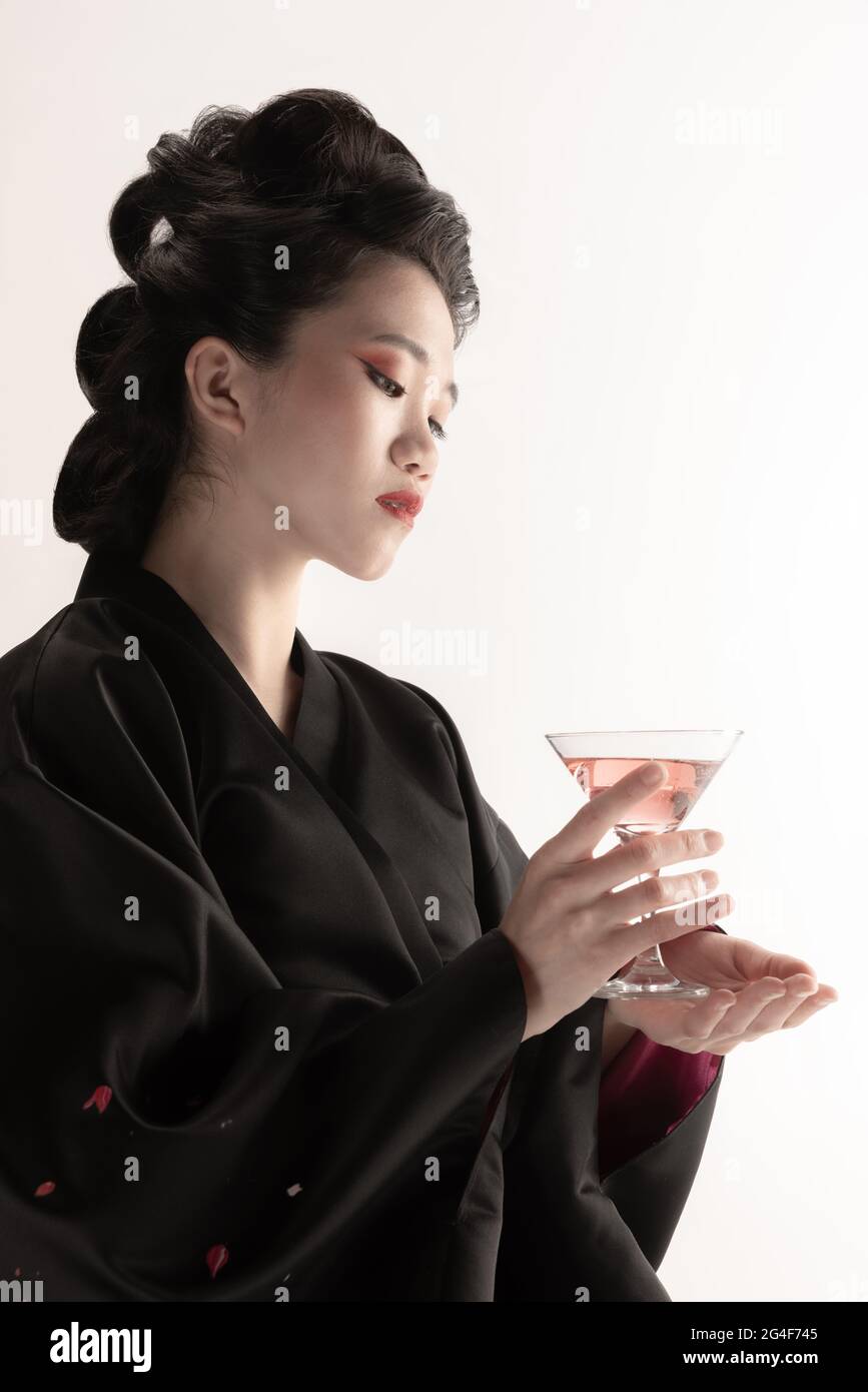 Portrait of young beautiful Japanese, woman in national attire kimono ...