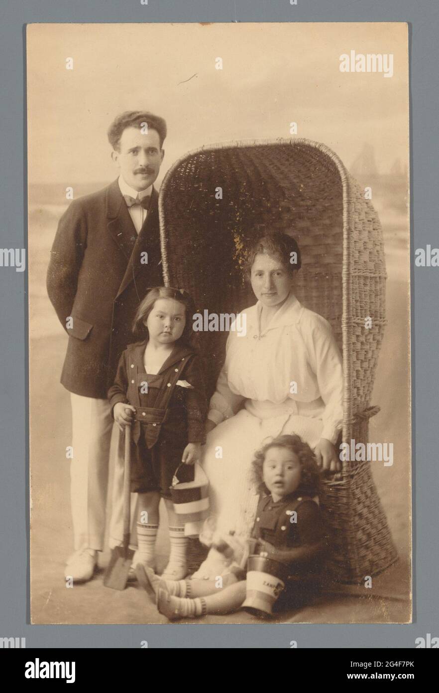 Studio portrait of an unknown family around a wicker beach chair Stock ...