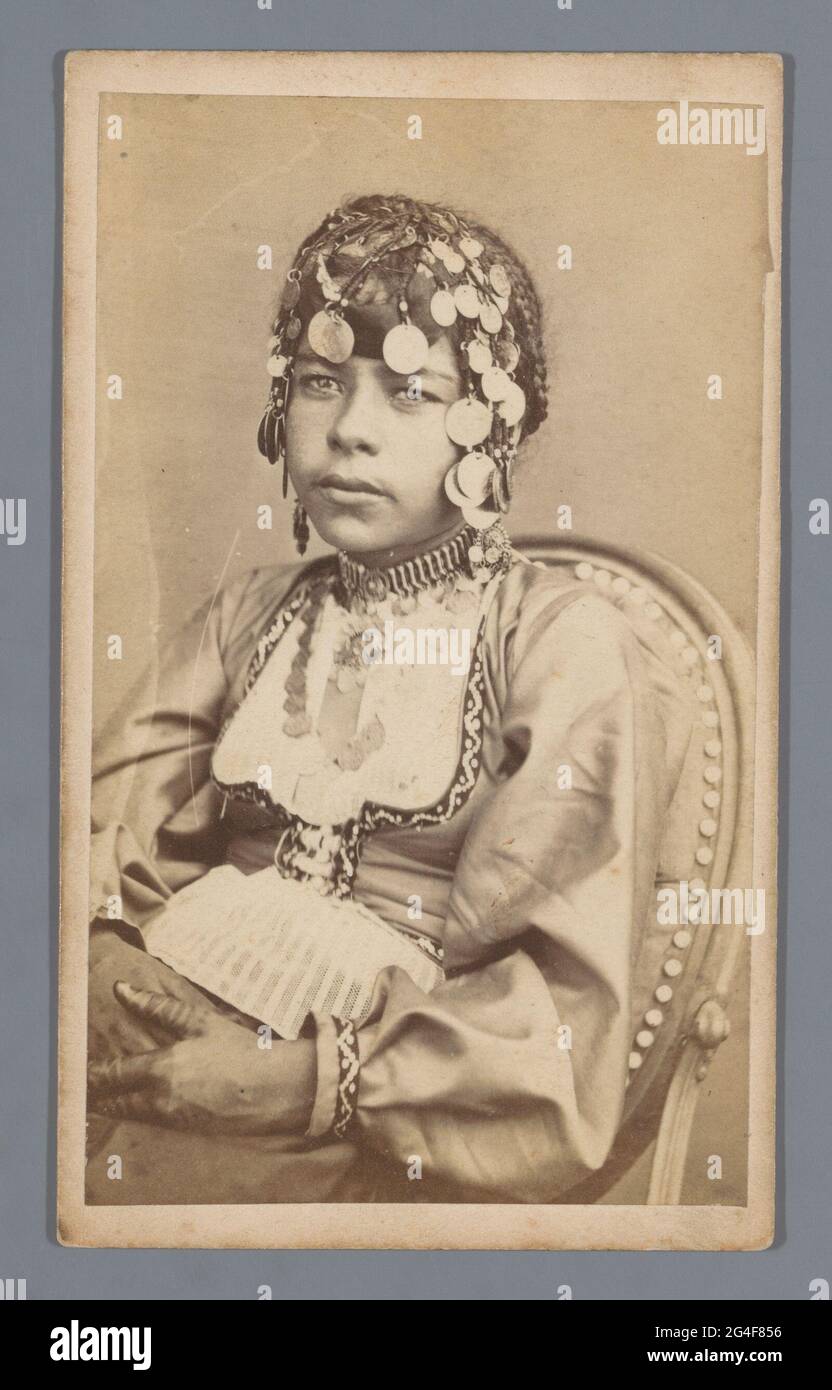 Portrait of young bedouin woman in traditional clothing with braided ...