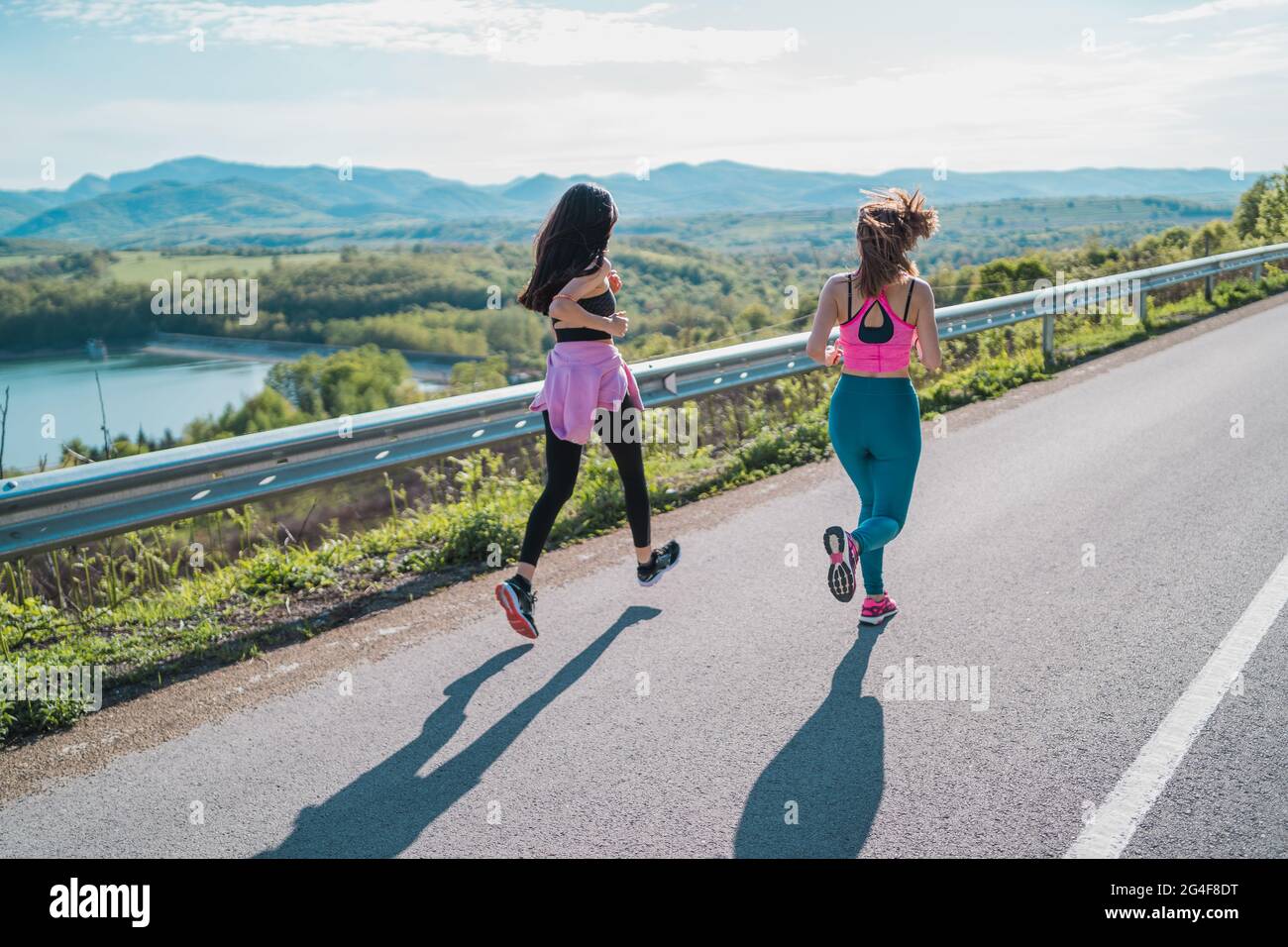 Fit sporty girls running jogging outdoors Stock Photo - Alamy