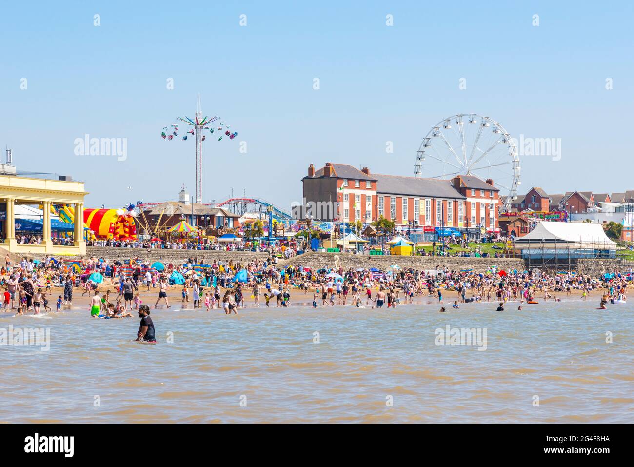 The beach at Barry Island seaside resort is crowded on a sunny Spring ...