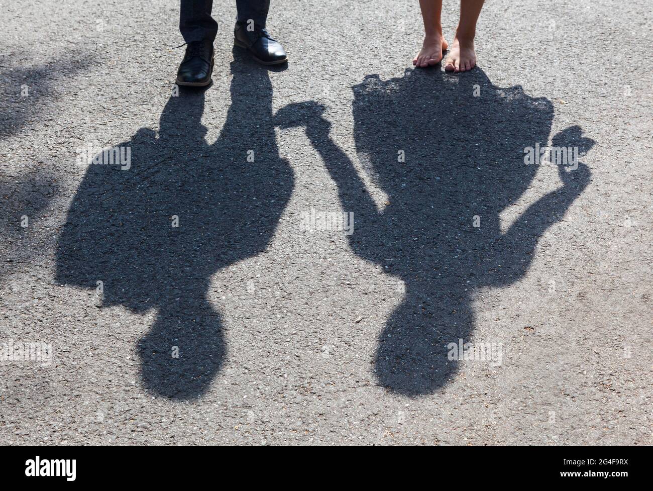 Shadow image of bride and groom on asphalt path, Germany Stock Photo ...