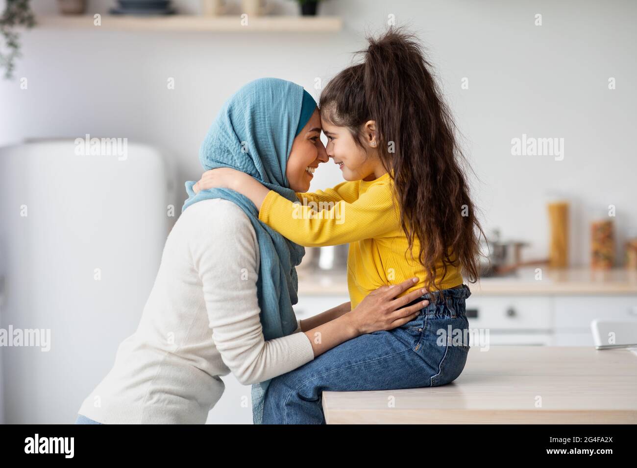 Mother's Day Concept. Cute Little Girl Embracing Her Muslim Mom In ...