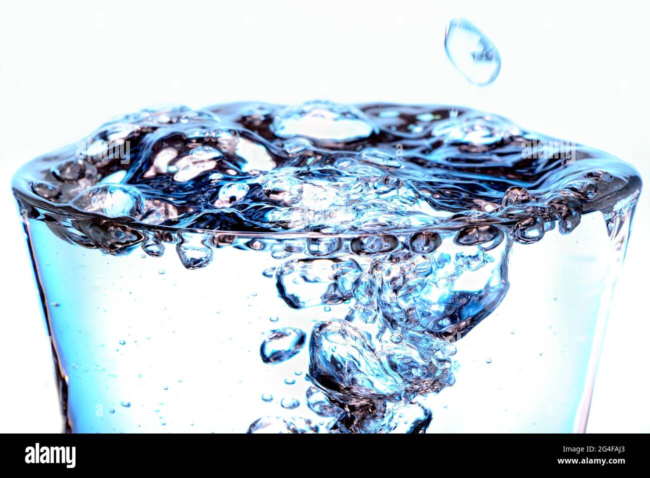 Glass filled with bubbling water Stock Photo - Alamy
