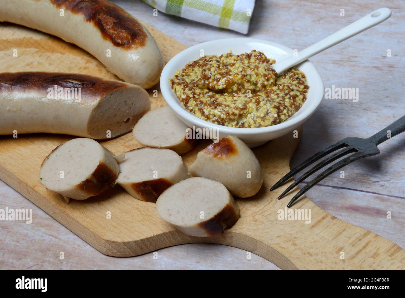 Sliced bratwurst and skin with Dijon mustard, Germany Stock Photo - Alamy