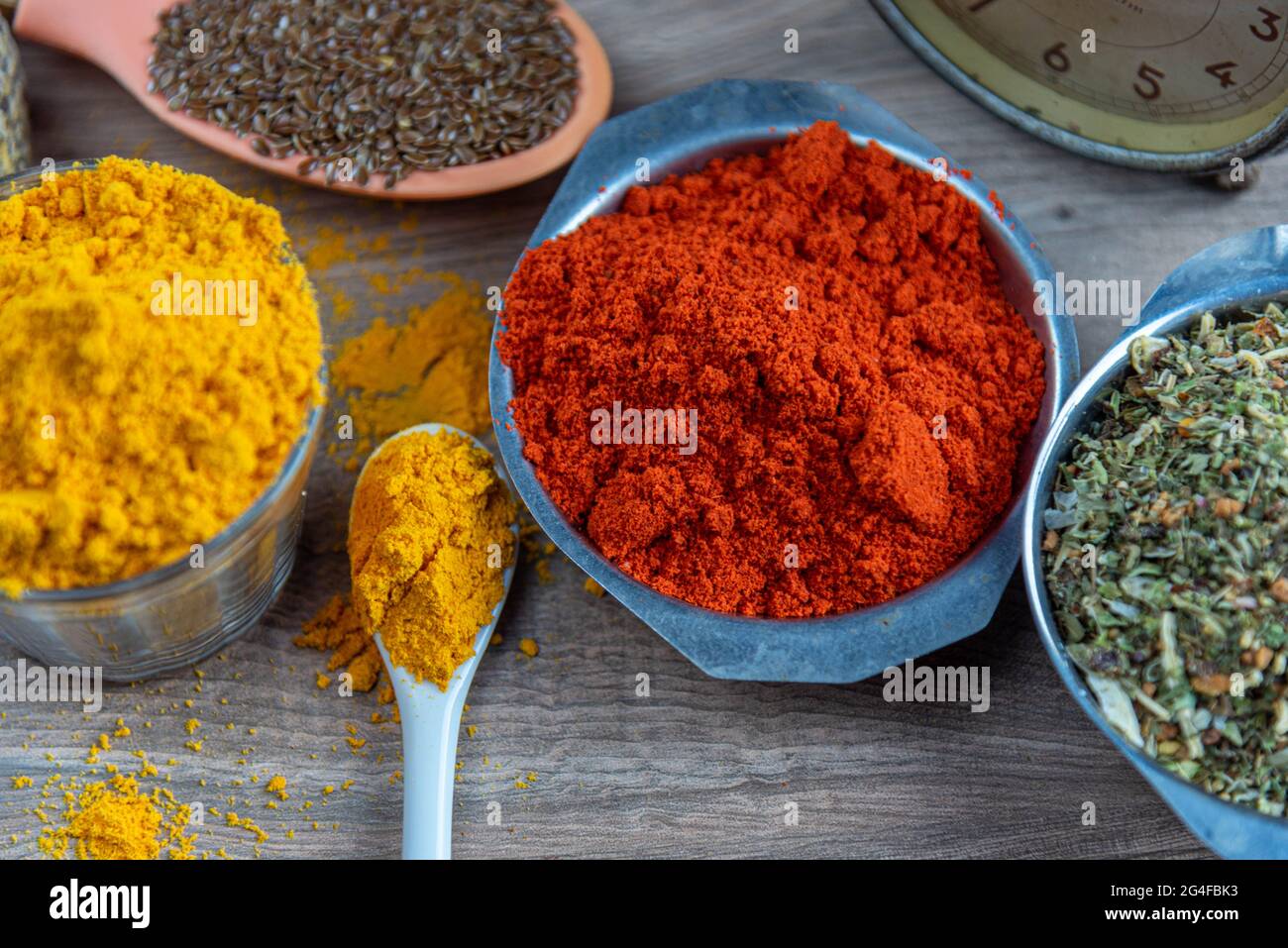 Colorful culinary spices and clock on wooden surface. Condiments used ...