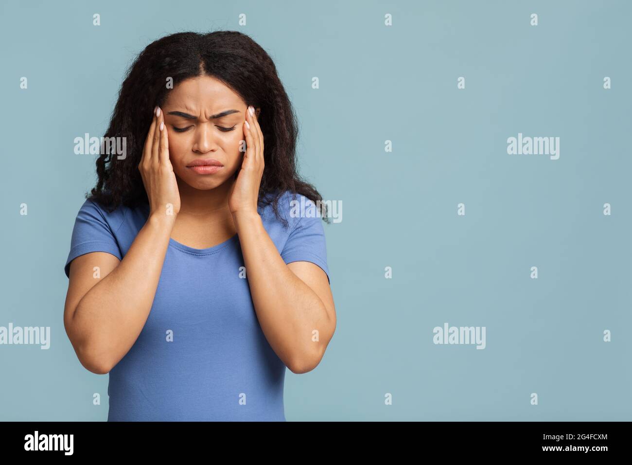Headache and migraine concept. African american lady suffering from ...