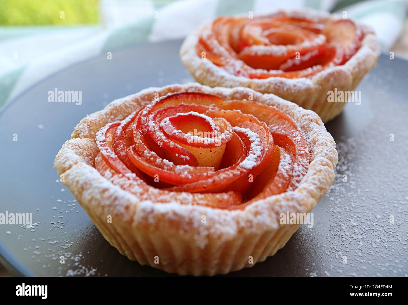 Closeup Mouthwatering Mini Apple Rose Tartlets on a Black Plate Stock ...
