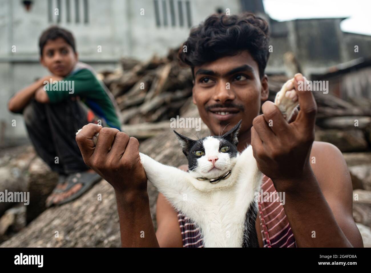 Dhaka, Dhaka, Bangladesh. 21st June, 2021. A boy sits on wood logs with ...