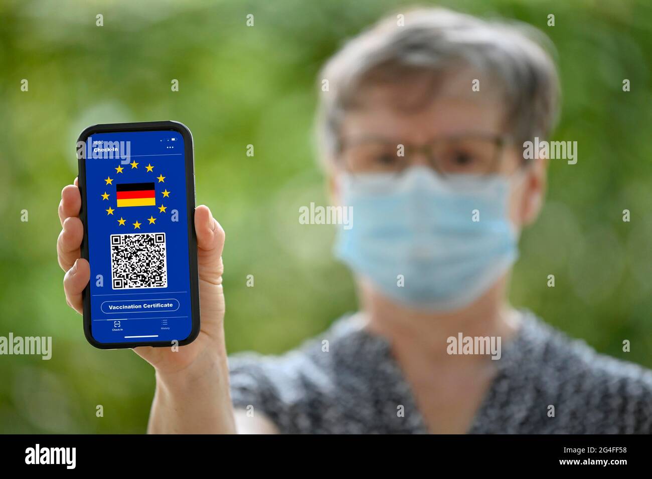 Symbol photo vaccination privilege, elderly woman shows smartphone with ...
