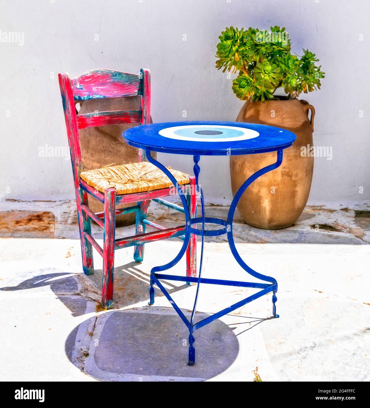 Charming narrow typical streets of Greek islands. coffe table and ...