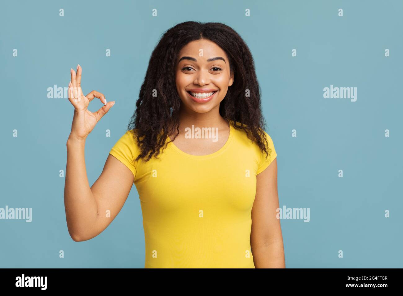 All is OK. Happy african american woman gesturing okey sign, looking ...