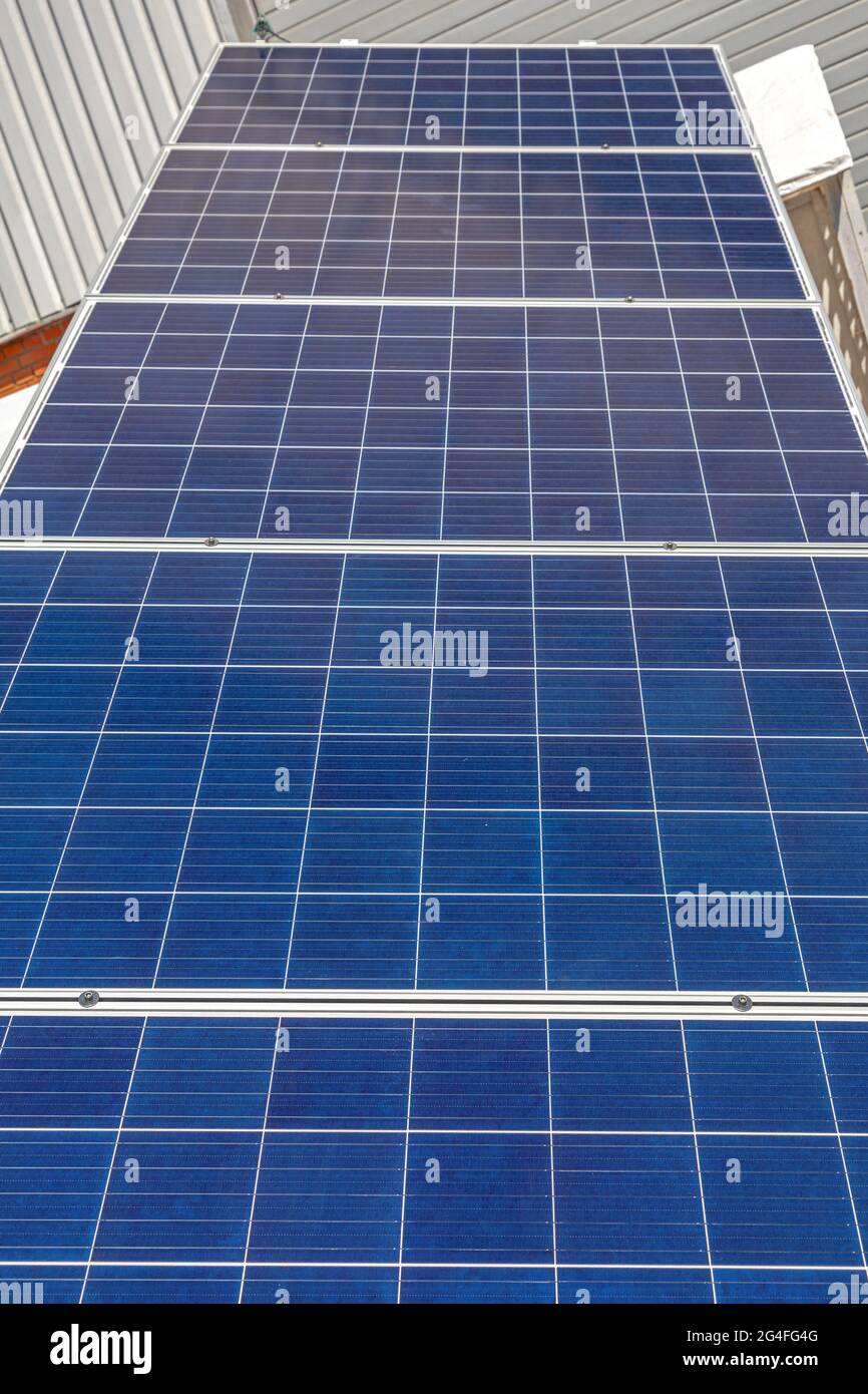 Multi Solar Panels in Row at Building Roof Top Stock Photo - Alamy