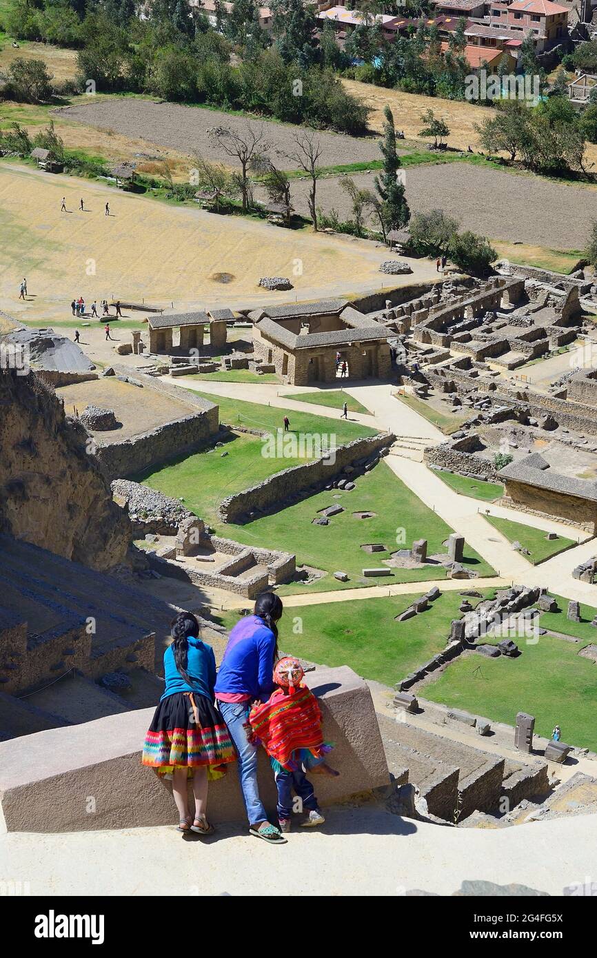 Three indigenous children in the Inca ruins, Ollantaytambo, Cusco ...