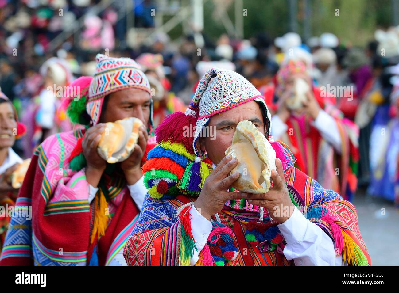 Indigenous man blows conch shell during parade on eve of Inti Raymi ...
