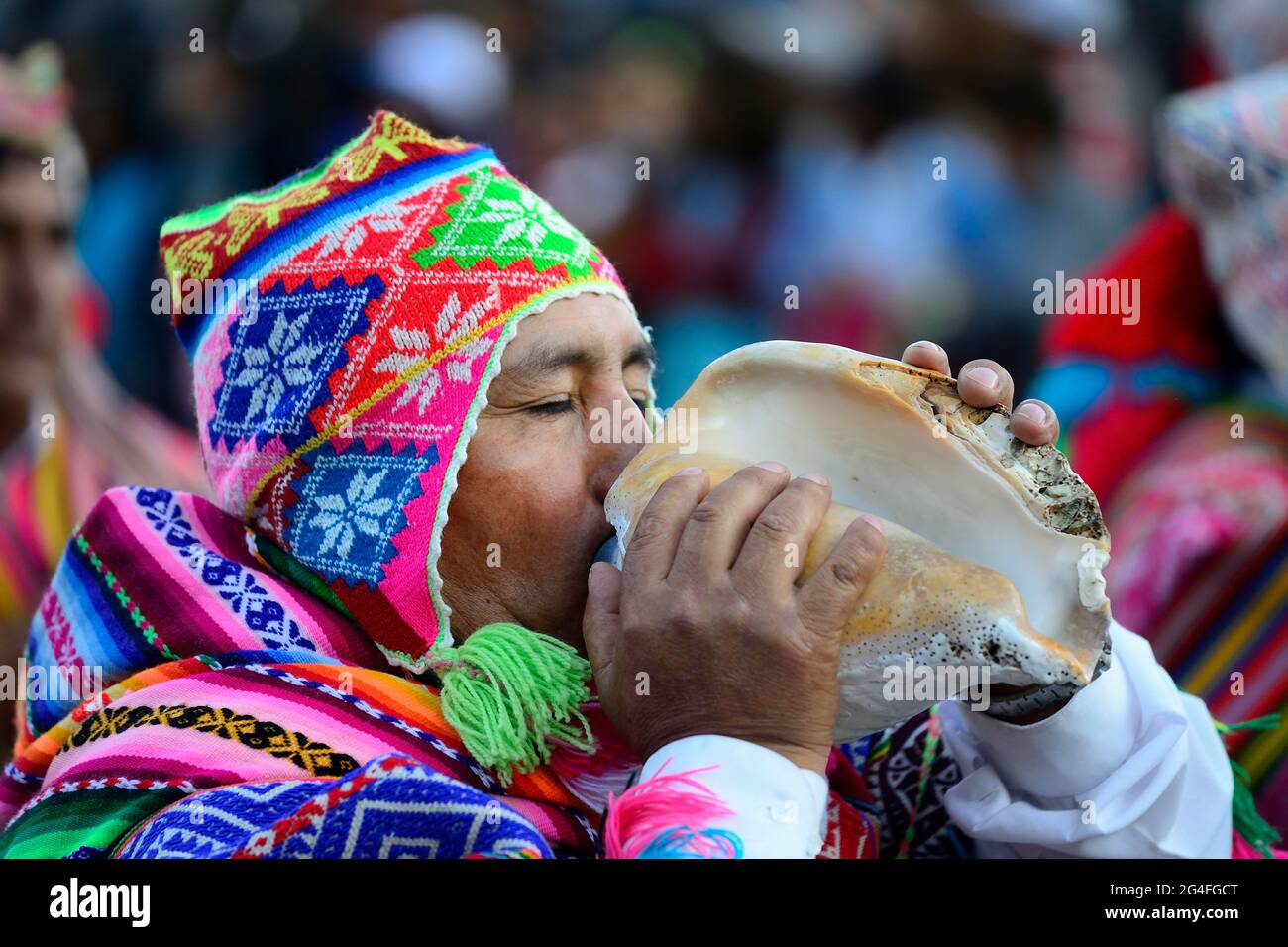 Indigenous man blows conch shell during parade on eve of Inti Raymi ...