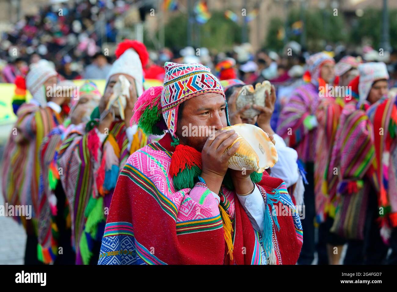 Indigenous man blows conch shell during parade on eve of Inti Raymi ...