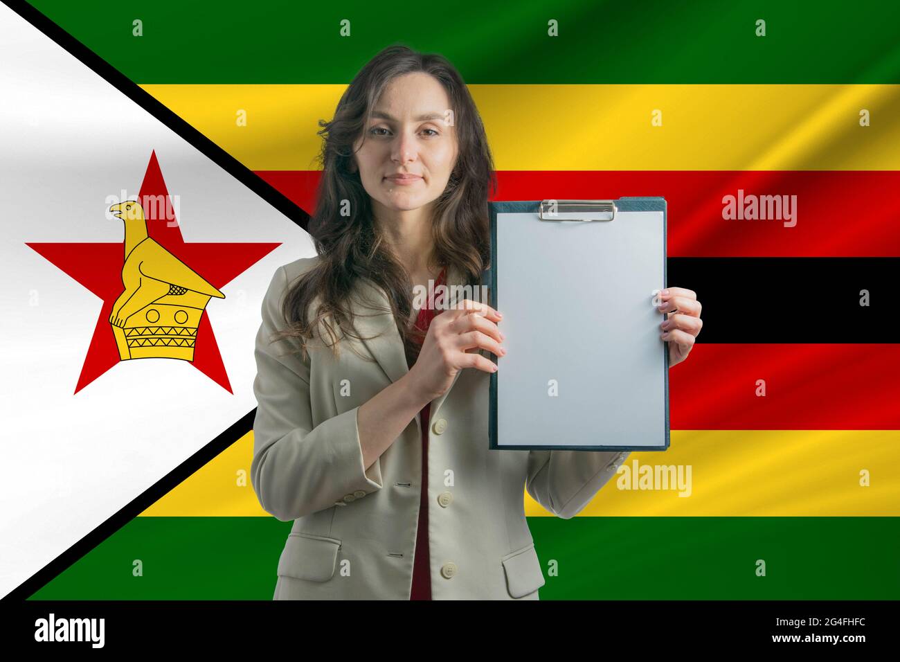 Study in Zimbabwe Beautiful woman holding a sheet of paper in her hands ...