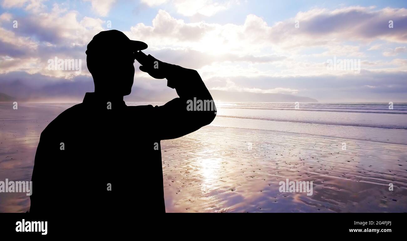 Composition of male soldier saluting over sea and blue sky Stock Photo ...