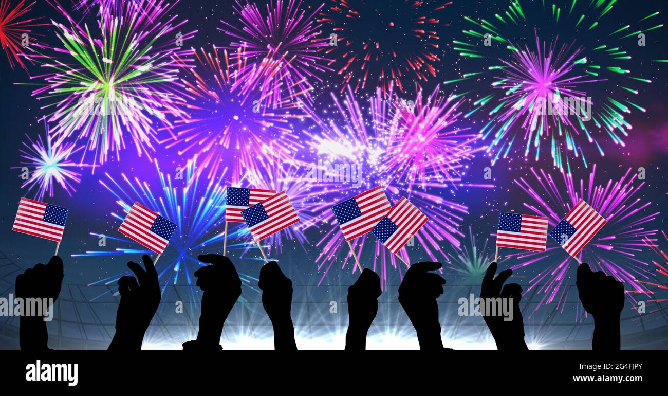 Composition of hands holding american flags over fireworks Stock Photo ...