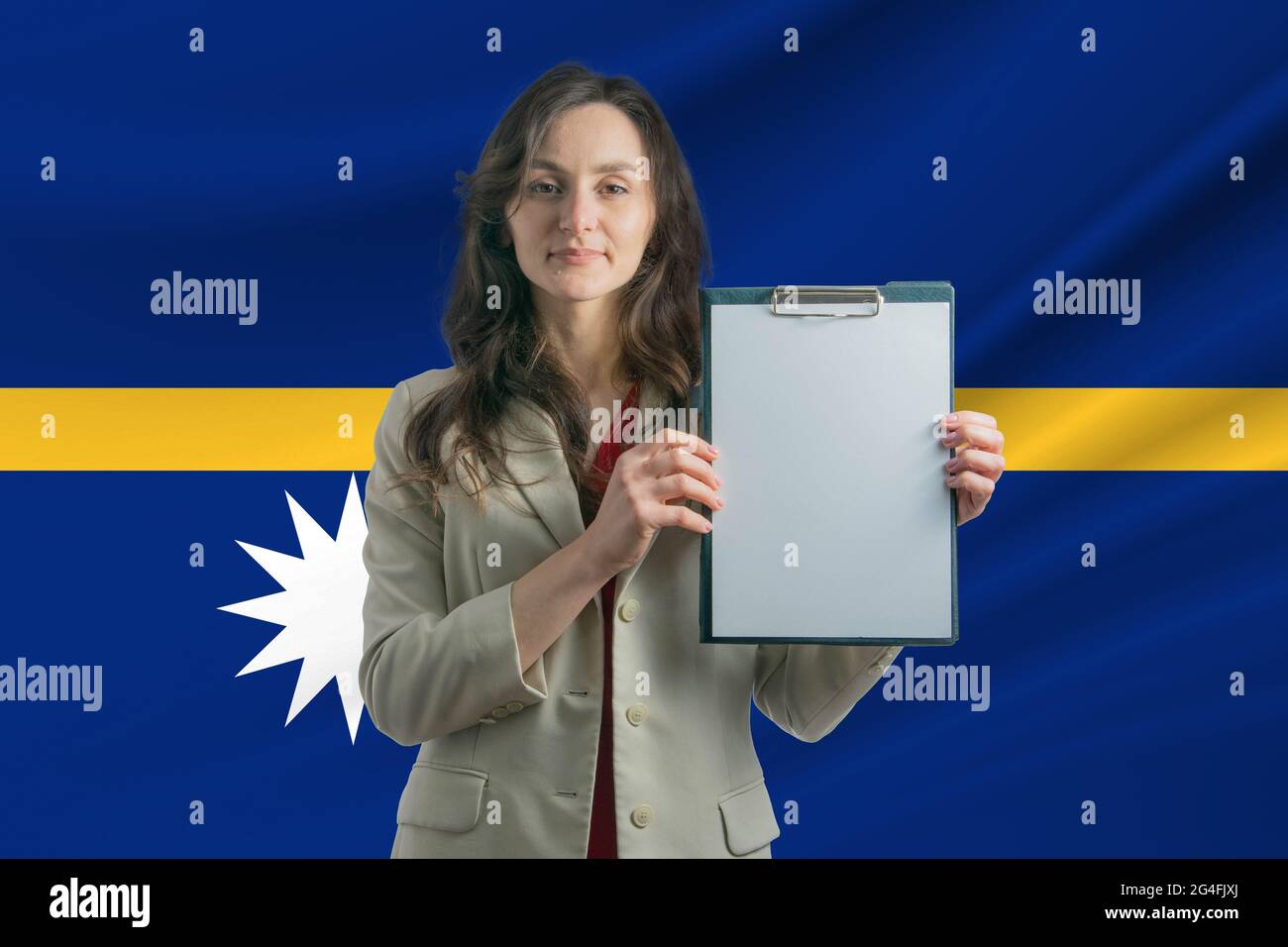 Study in Nauru. Beautiful woman holding a sheet of paper in her hands ...