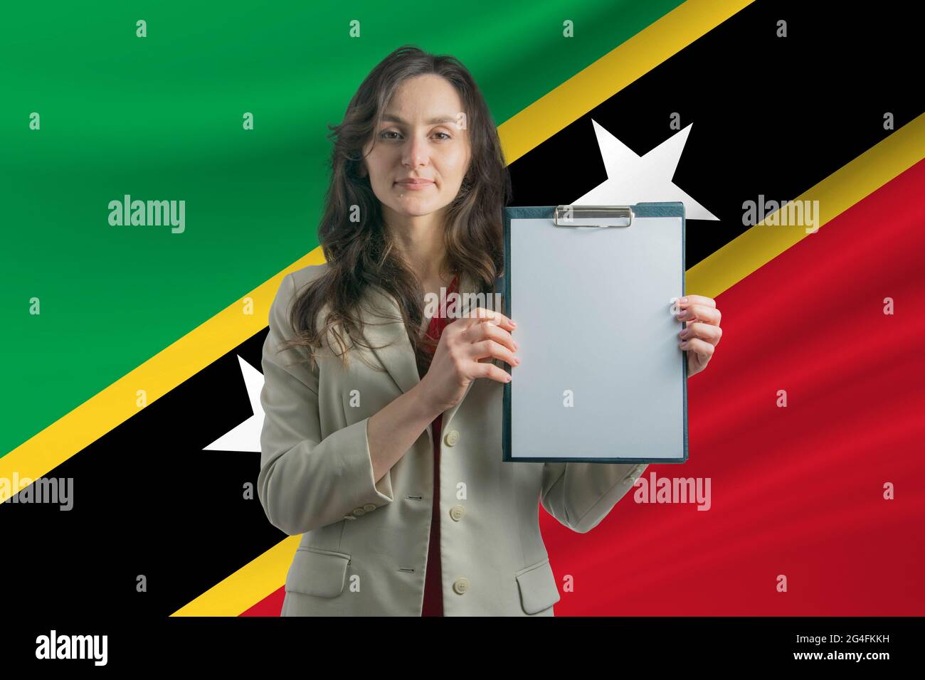 Study in St. Kitts and Nevis. Beautiful woman holding a sheet of paper ...