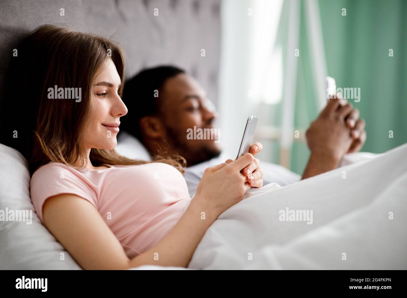 Gadget addiction concept. Young multiethnic family using smartphones ...