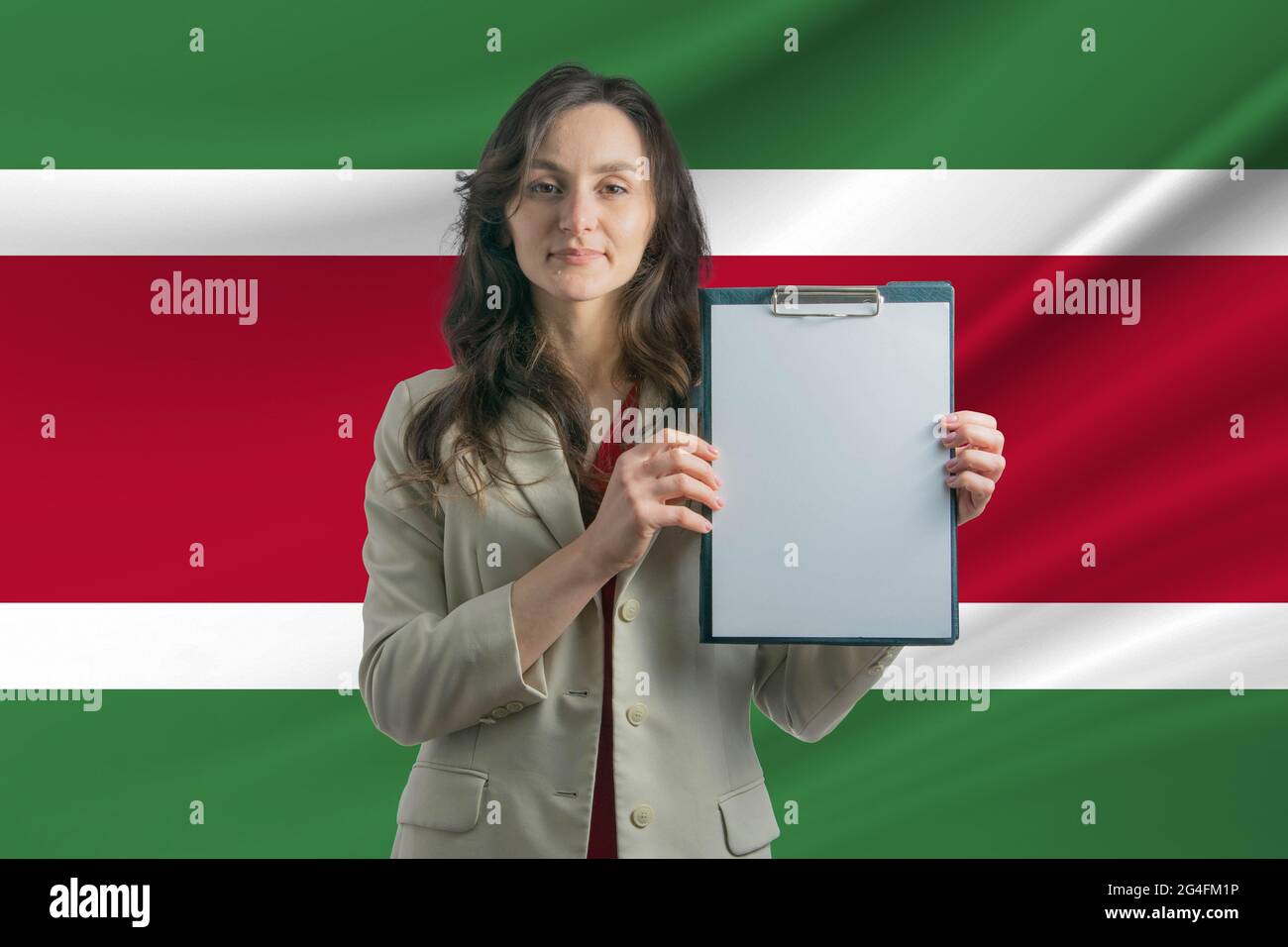 Study in Suriname. Beautiful woman holding a sheet of paper in her ...