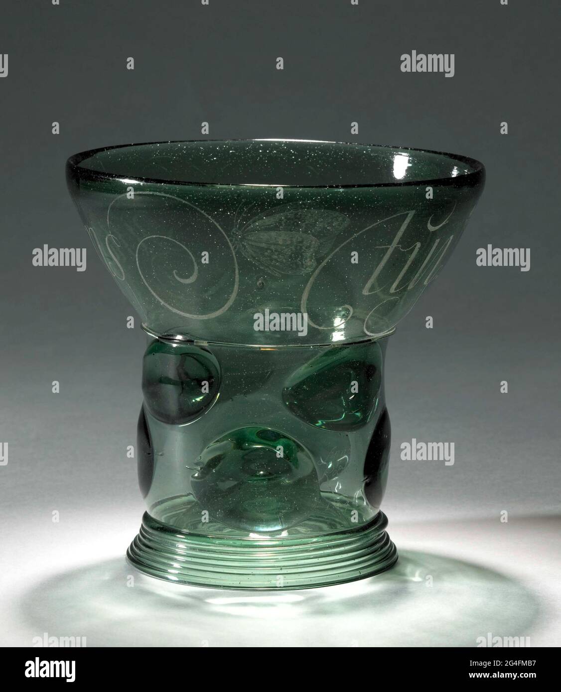 . Engraved on the bowl of this glass are the words ‘Vincens tui ...