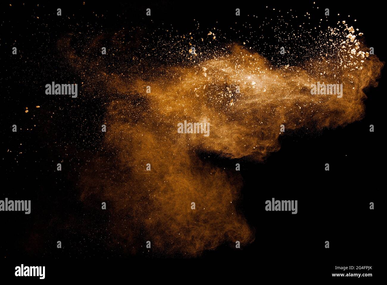 Abstract brown dust explosion on black background.Brown powder ...