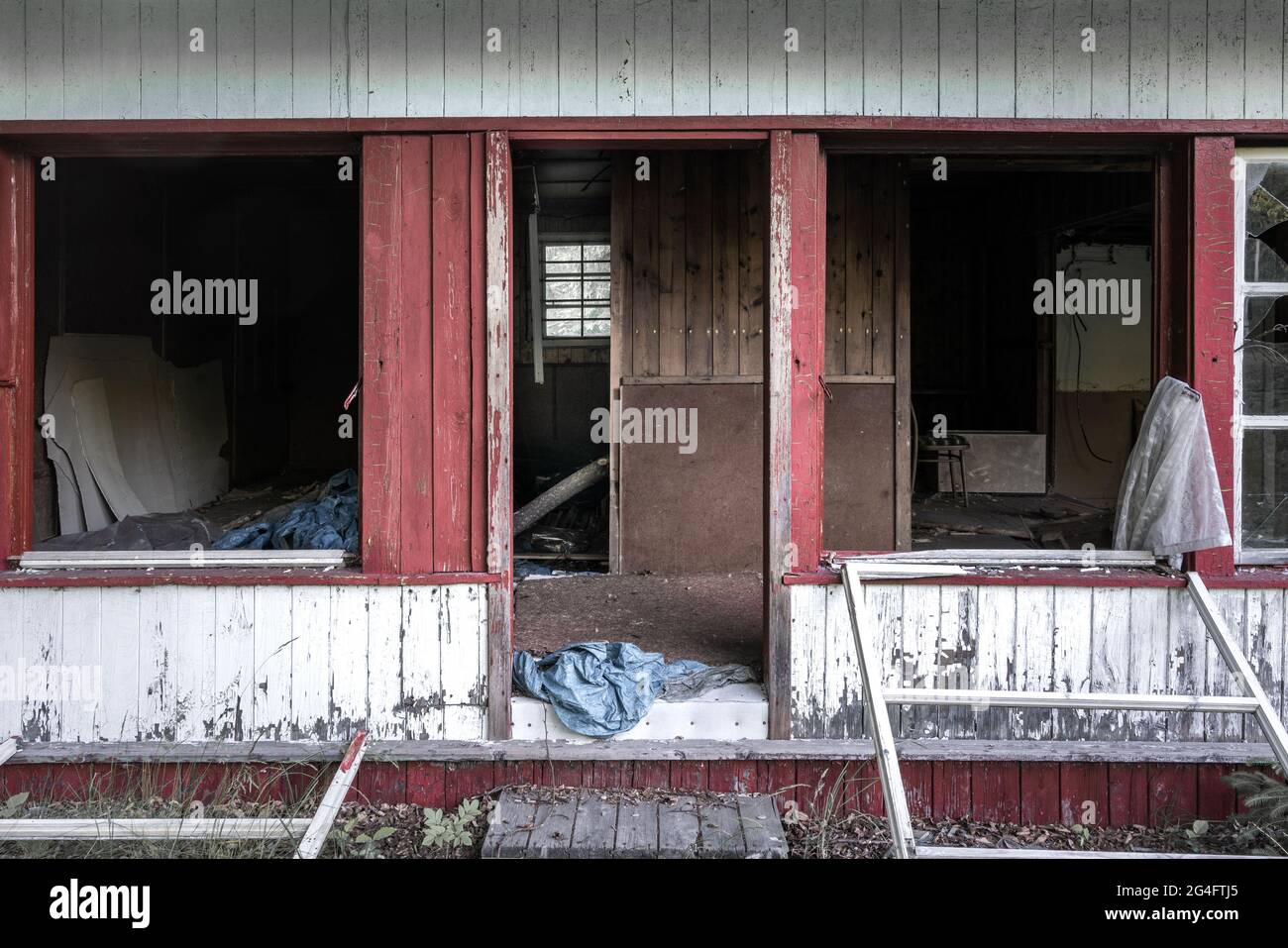 Old abandoned wooden house falling apart. Broken windows, scattered ...