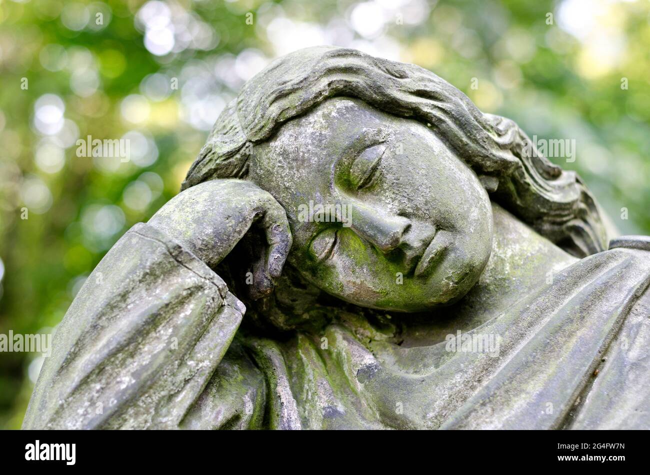 Weathered statue of sleeping Angel - tombstone at old Prague cemetery ...
