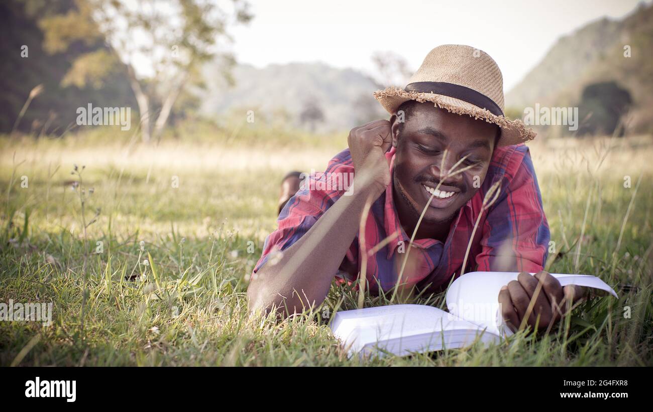 African american man reading tree hi-res stock photography and images ...